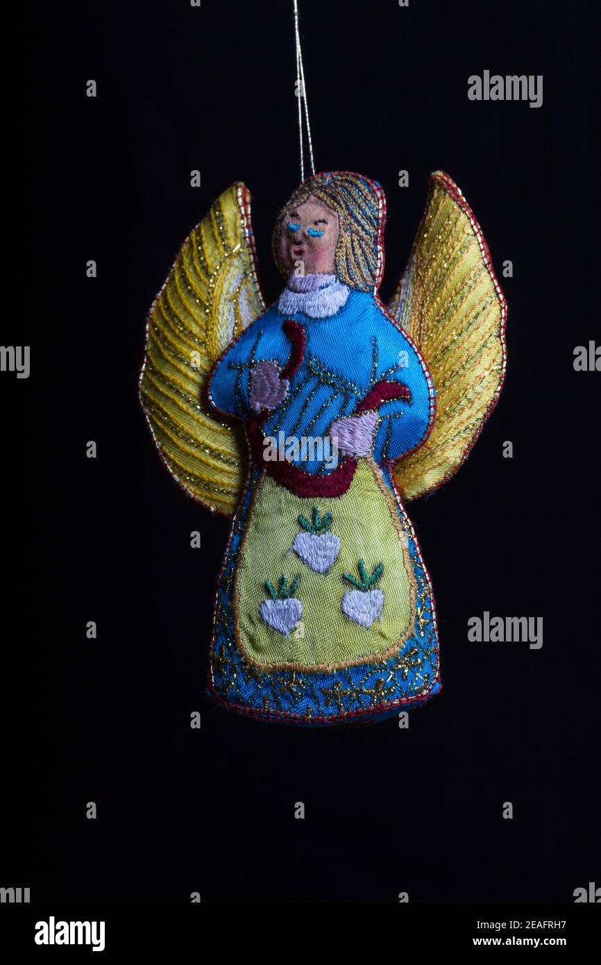 Christmas decorations on string angels with black background Stock ...