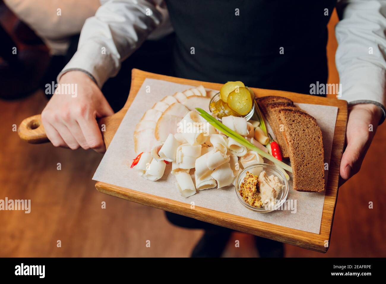 In a beautiful restaurant, a waiter brings a ready-made dish for a ...