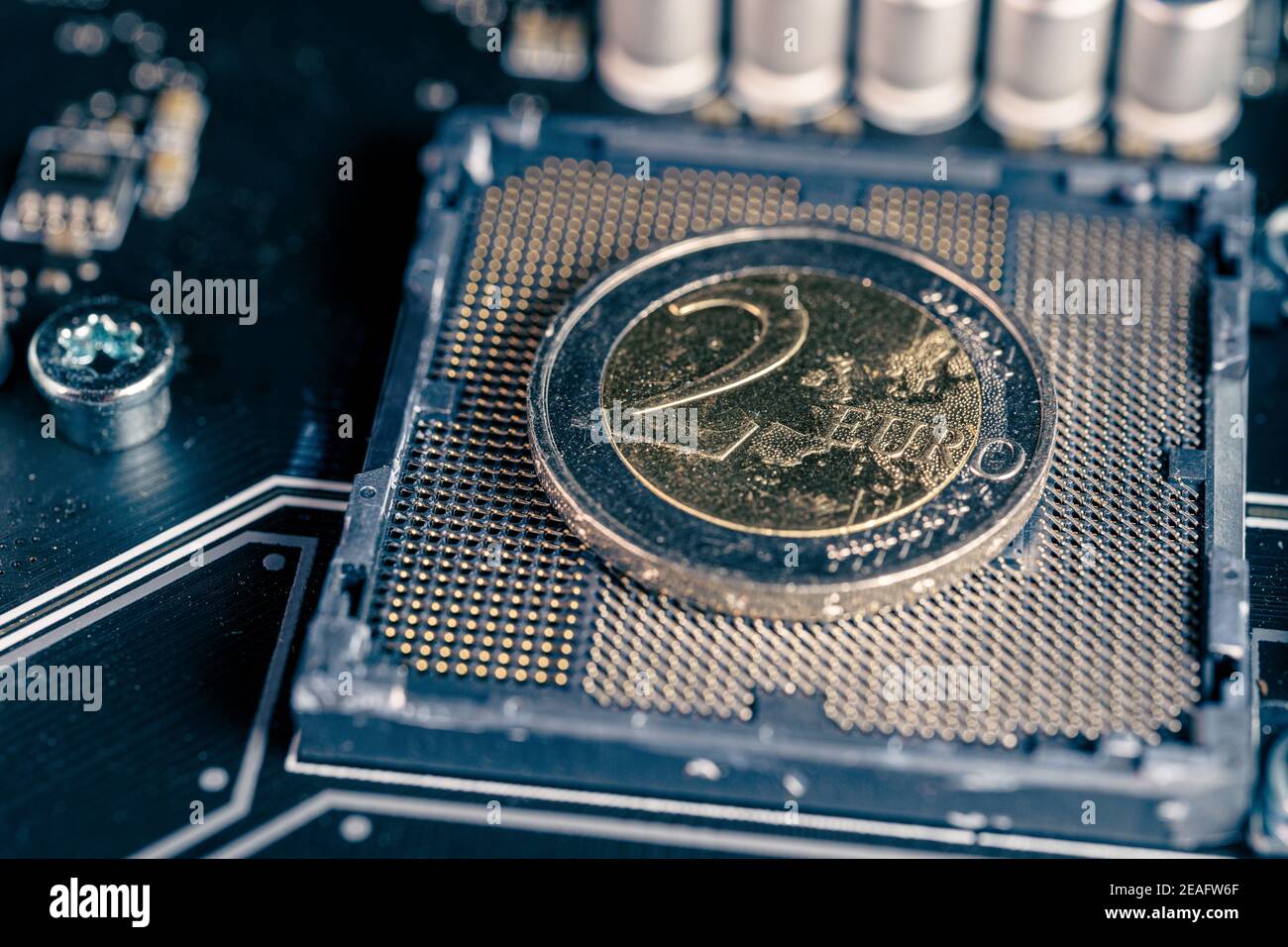 2 euro coin over a CPU slot in a motherboard, symbolizing the Digital ...