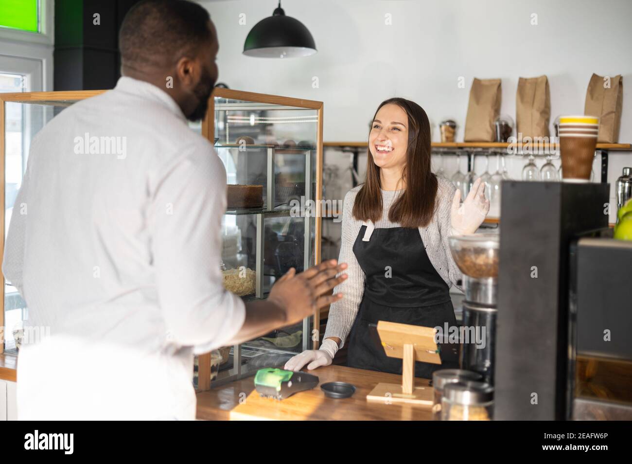 Friendly and helpful waitress is serving an African-American male ...