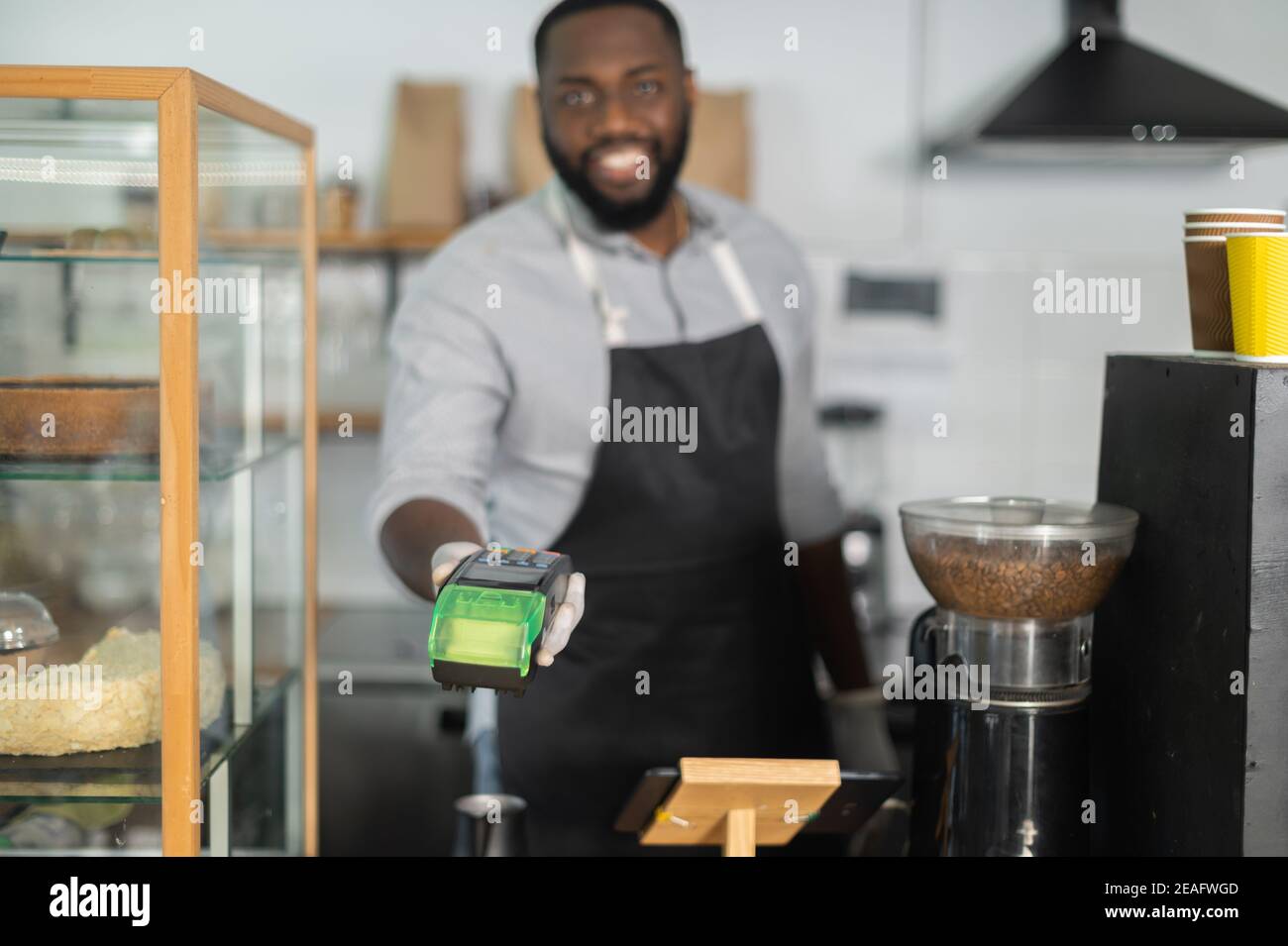 Contactless payment concept. A POS payment terminal in hand of an ...
