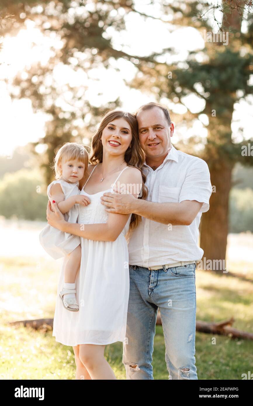 Family enjoying life together in the summer park. People having fun in ...