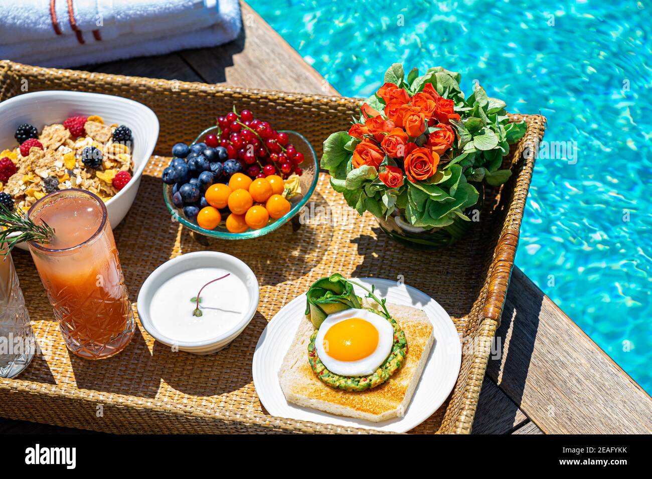 tray with assorted breakfast meal and drinks near swimming pool Stock ...