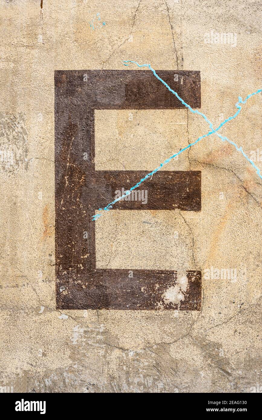 Painted letter E on a weathered house wall Stock Photo - Alamy