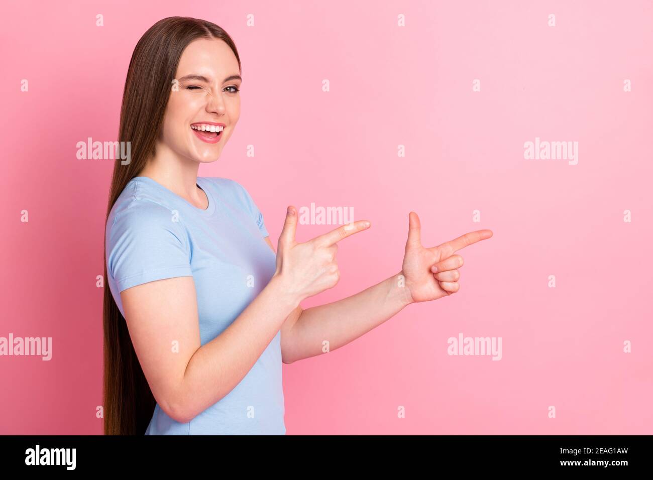 Photo portrait profile of winking girl pointing two fingers to side ...