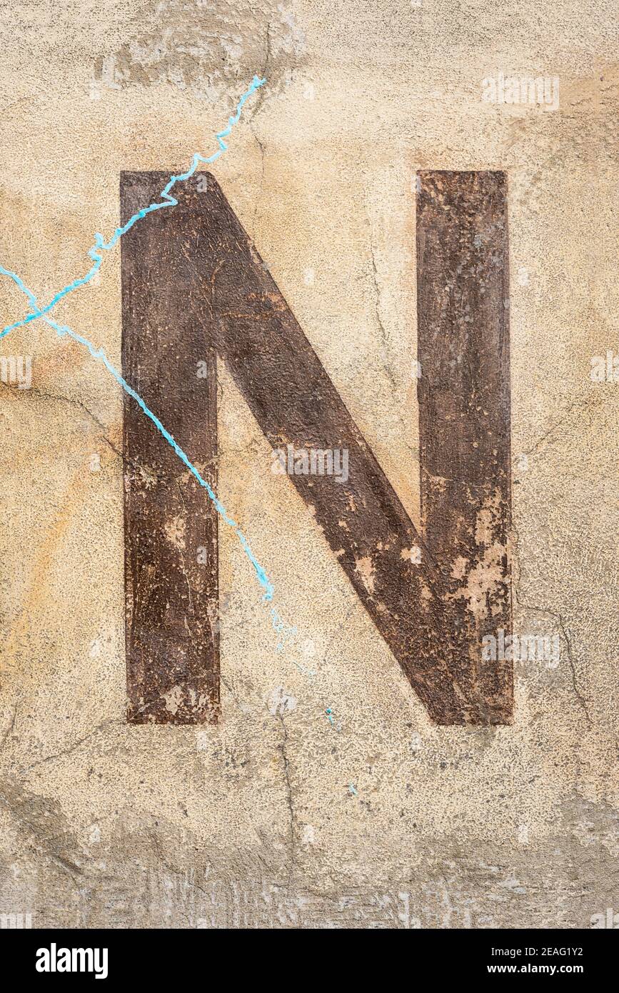 Painted letter N on a weathered house wall Stock Photo - Alamy