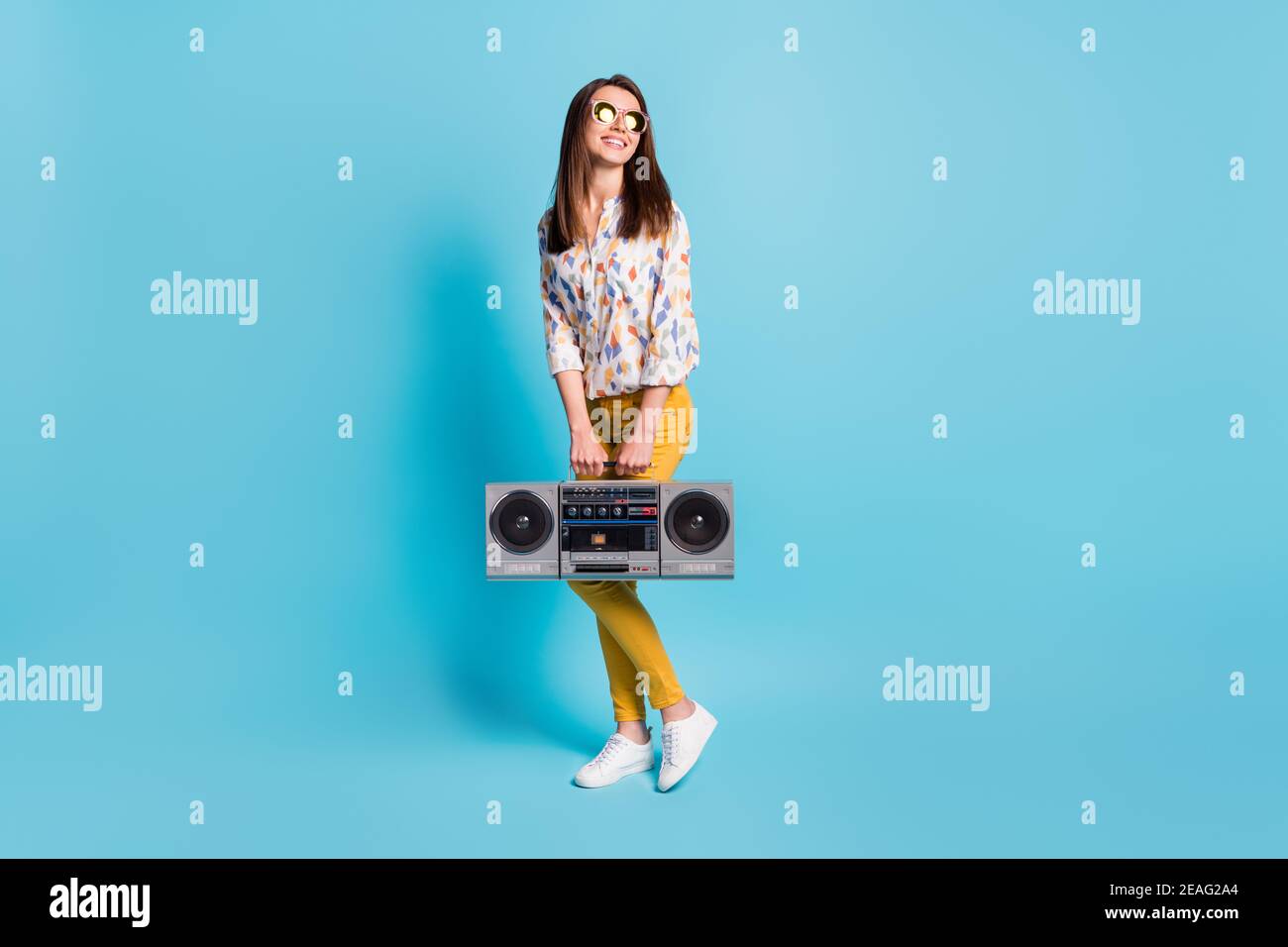 Full length body size photo of smiling girl carrying retro boom-box ...