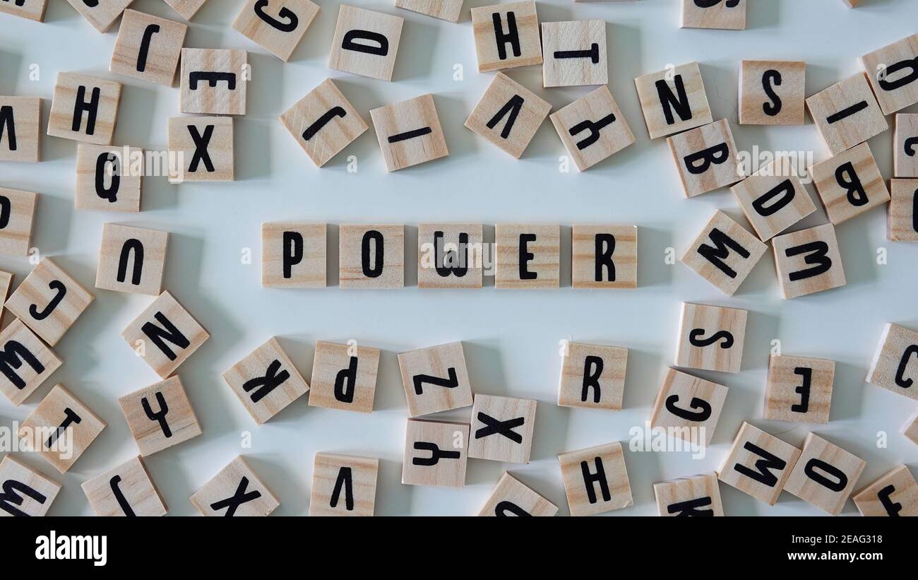 The word power spelled out in wooden craft letters surrounded by ...
