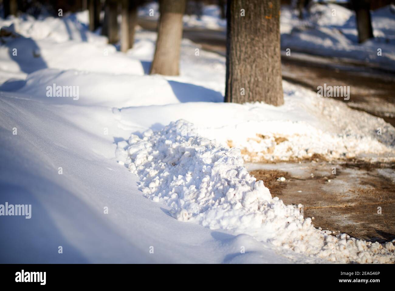 Piles of snow cleared from the sidewalks Stock Photo - Alamy