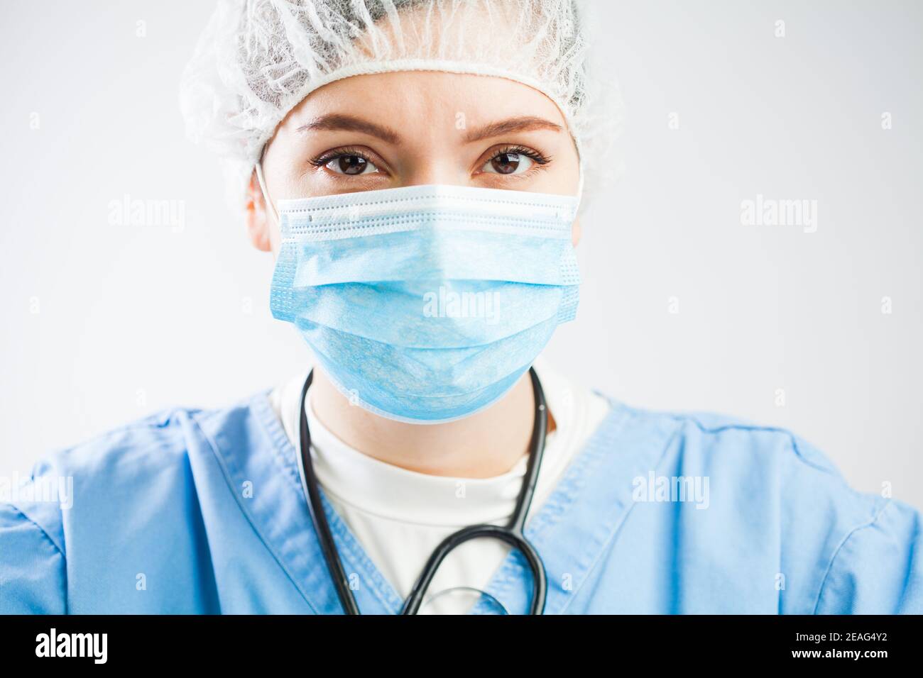 Concerned caucasian UK NHS doctor isolated on white background portrait ...