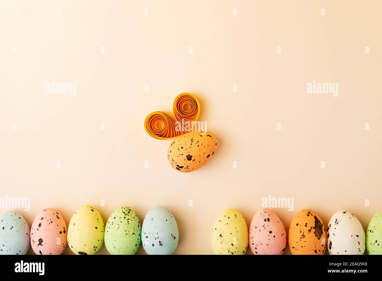 Row from multicolored eggs on the pastel background.Funny egg like a ...