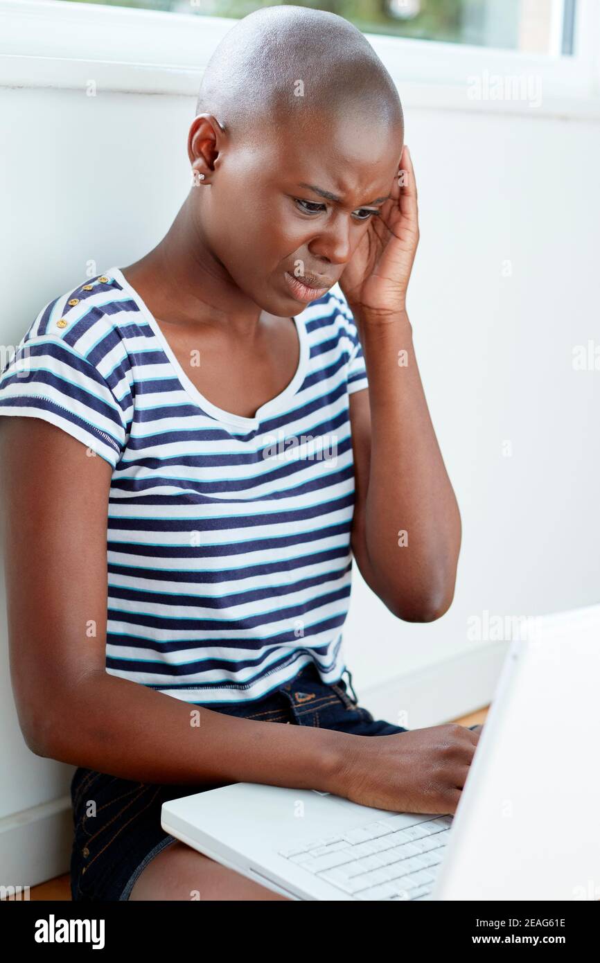 Ethnic Student girl sat on the floor studying Stock Photo - Alamy