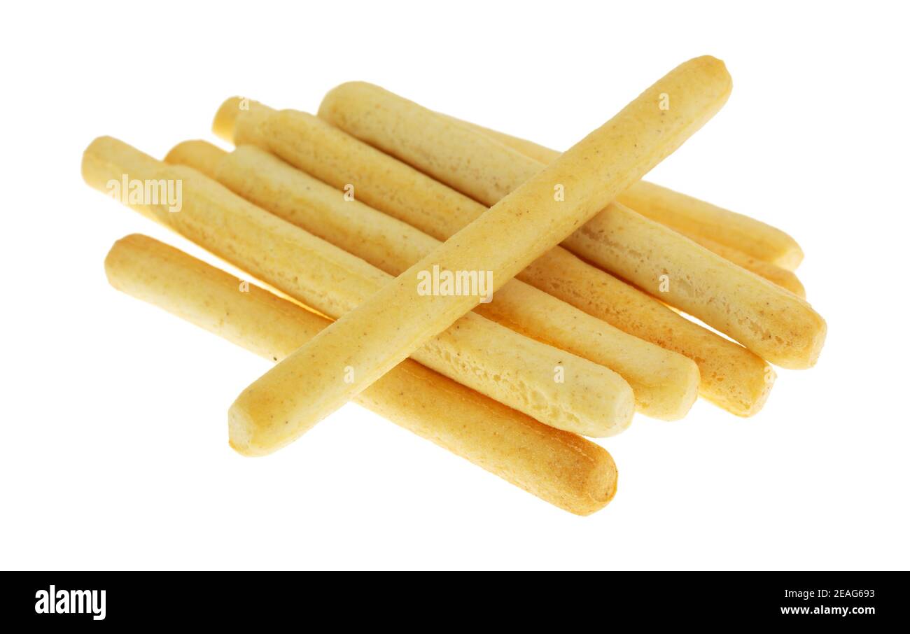 Several crunchy breadsticks with one at an angle isolated on a white ...