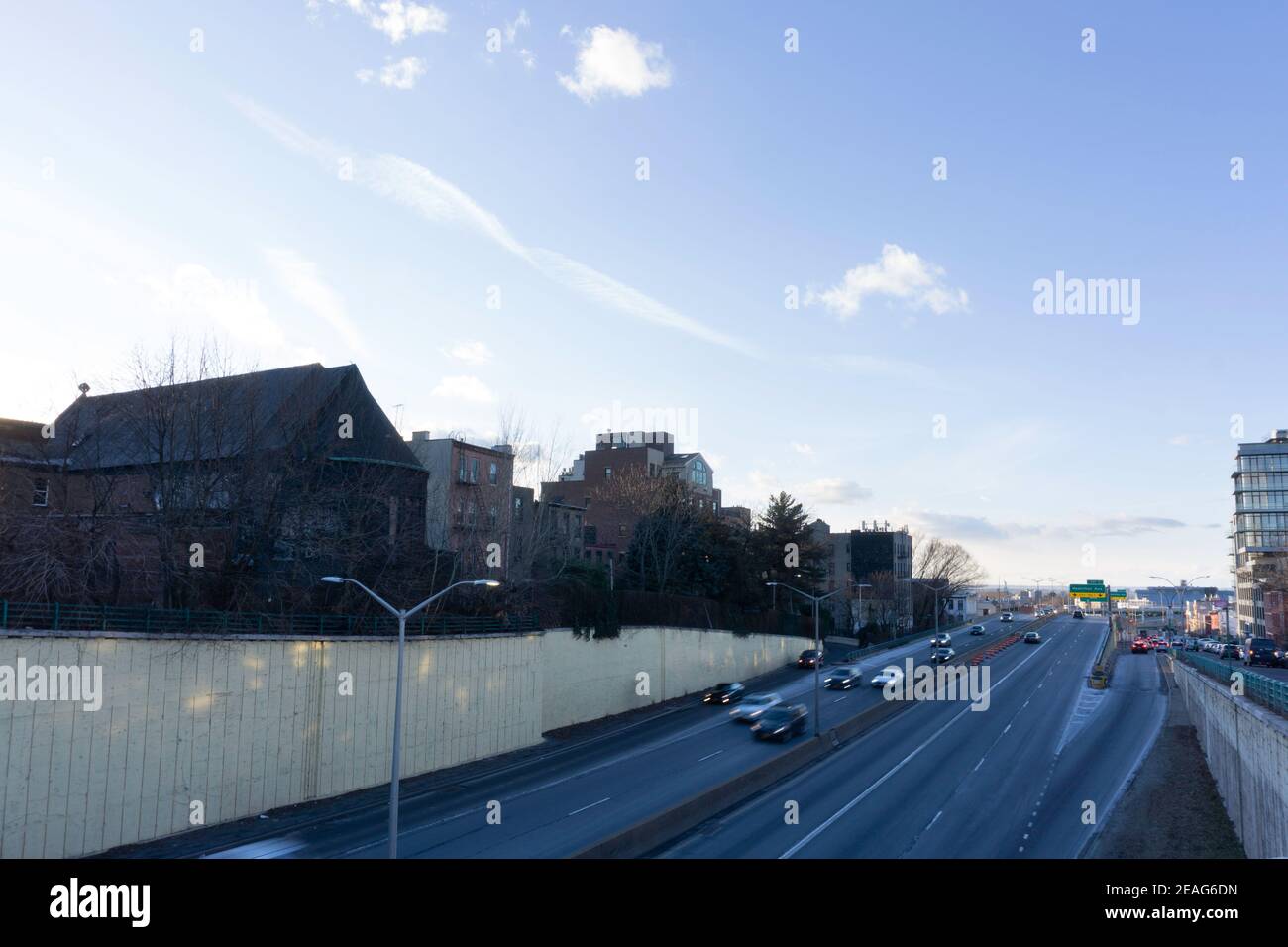Highway view from above with speeding cars and apartment buildings in ...