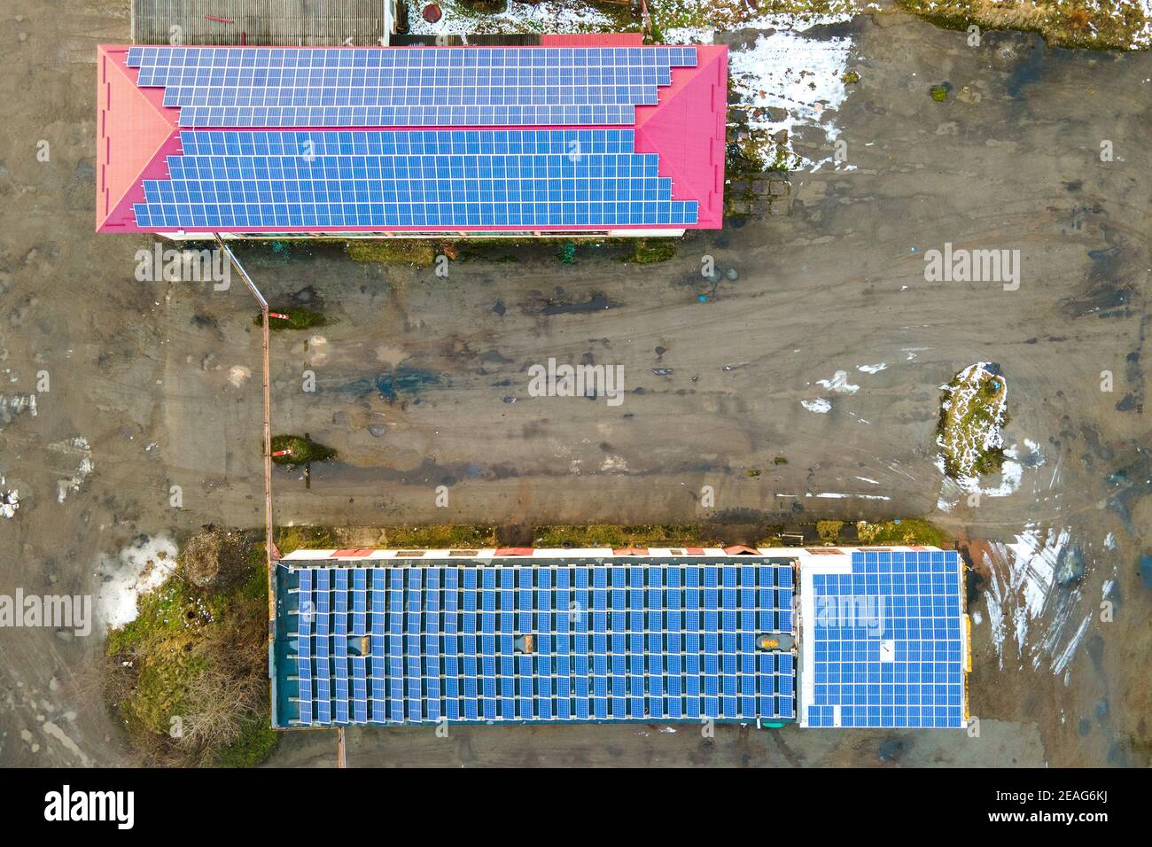 Blue photovoltaic solar panels mounted on industrial building roof for ...