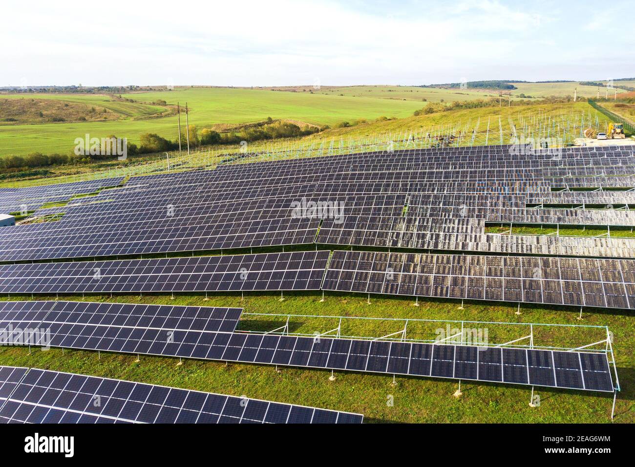 Aerial view of solar power plant under construction on green field ...