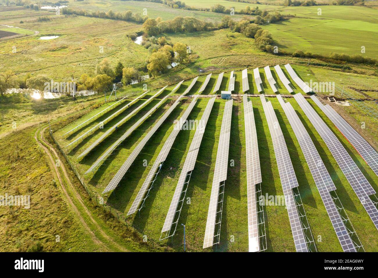 Aerial view of solar power plant under construction on green field ...