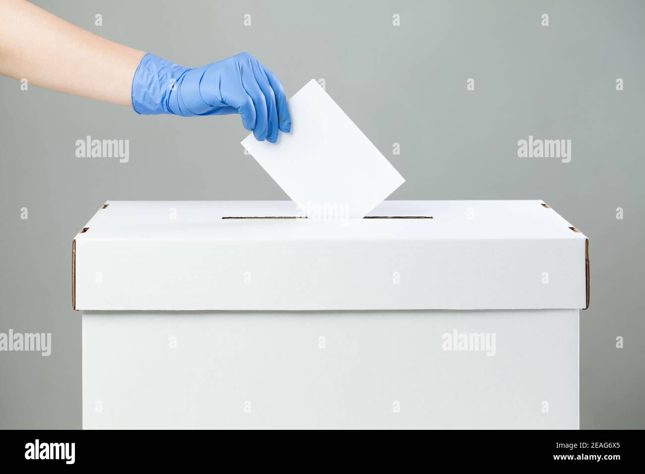Hand putting vote into ballot box hi-res stock photography and images ...