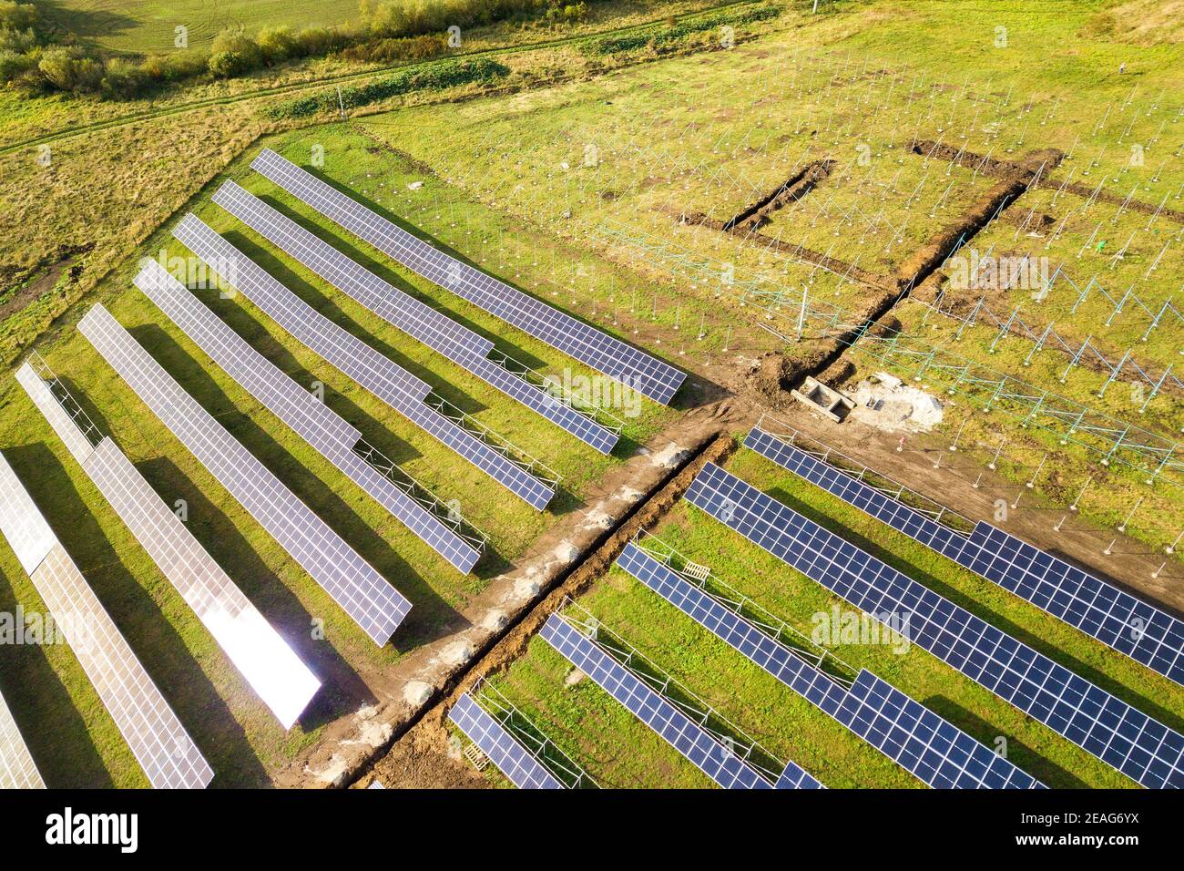 Aerial view of solar power plant under construction on green field ...