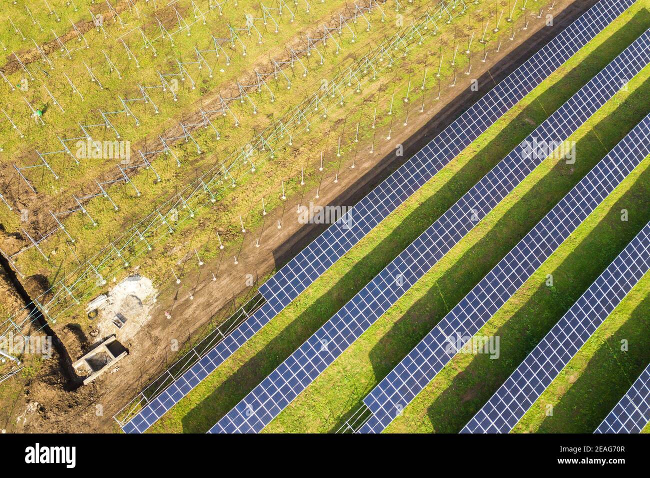 Aerial view of solar power plant under construction on green field ...