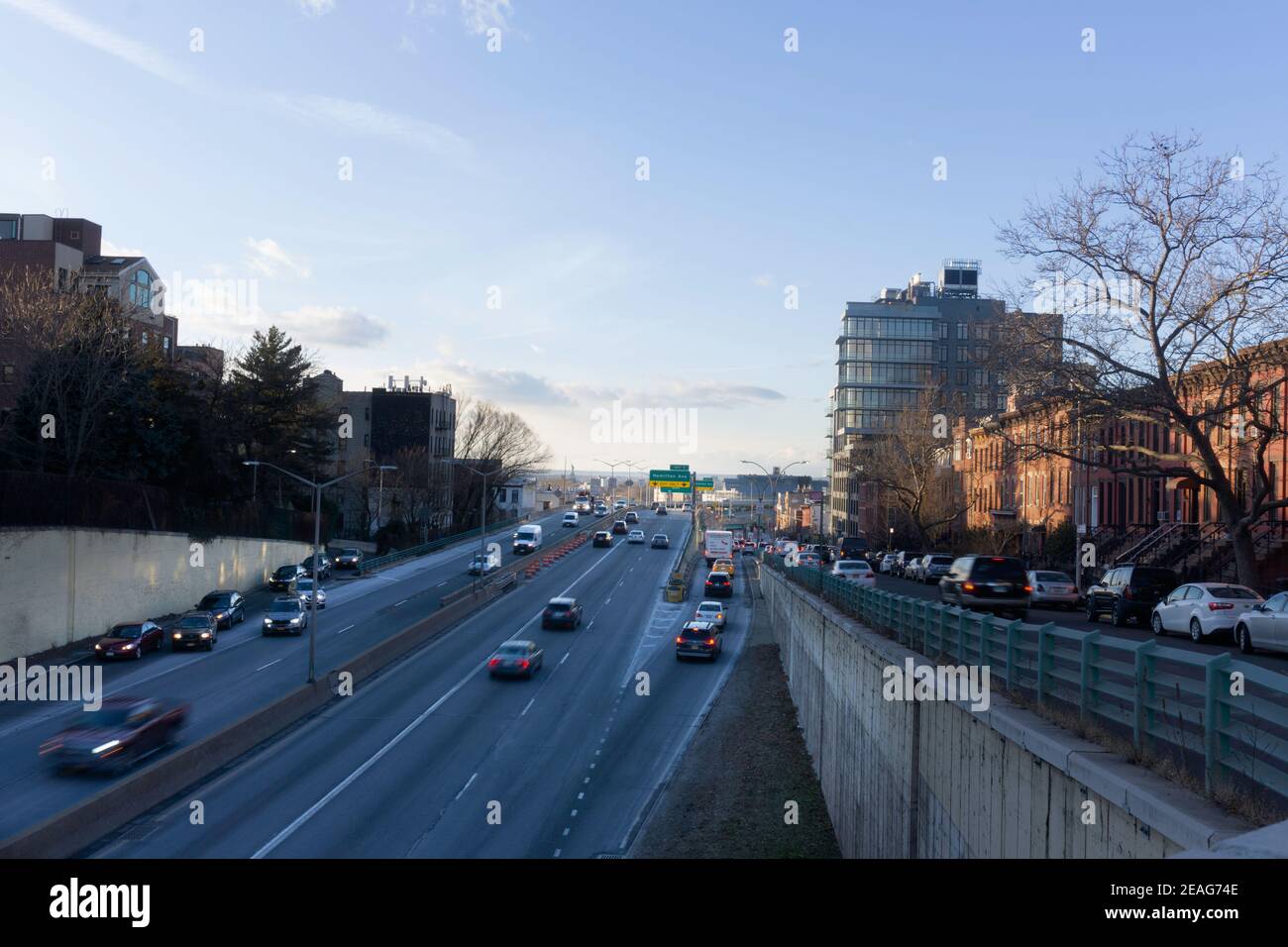 Highway view from above with speeding cars and apartment buildings in ...