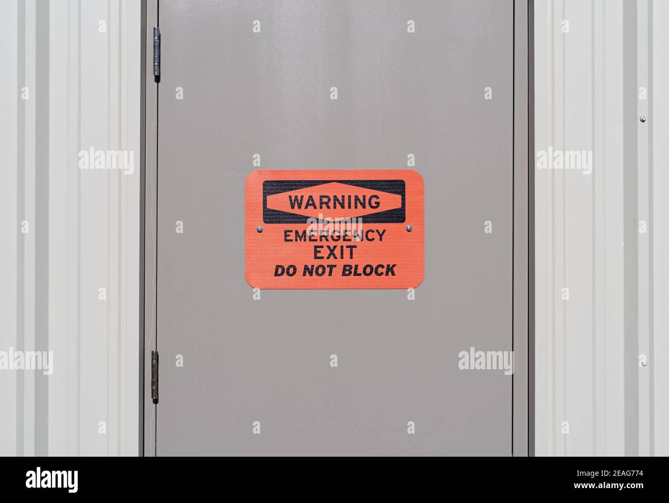An Emergency Exit Warning sign with Do Not Block in bold letters bolted ...