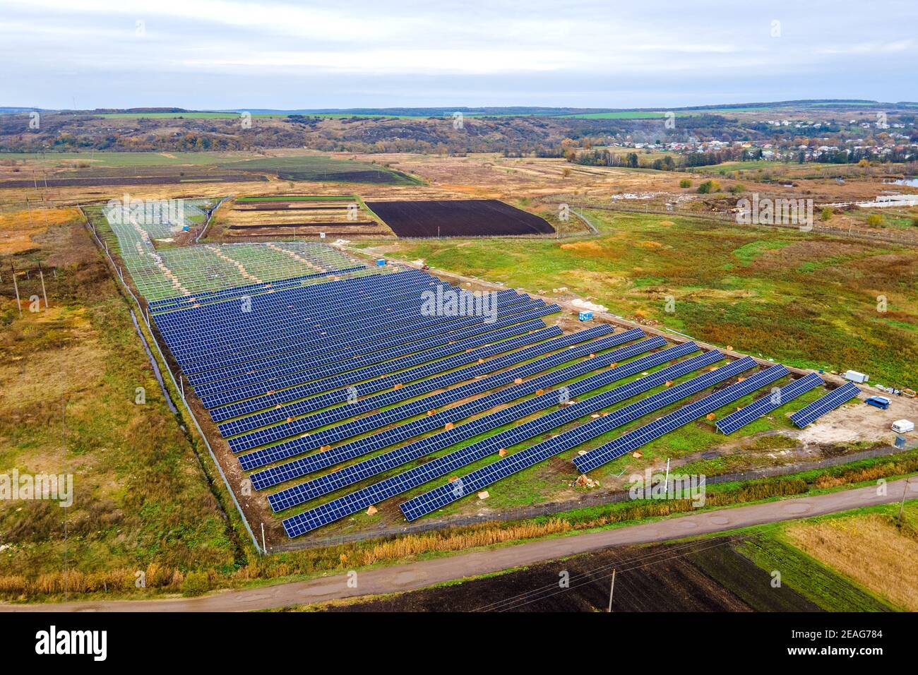 Aerial view of solar power plant under construction on green field ...