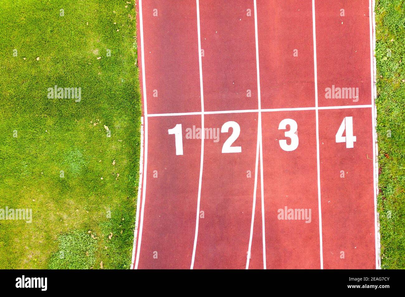 Aerial view of sports stadium with red running tracks with numbers on ...