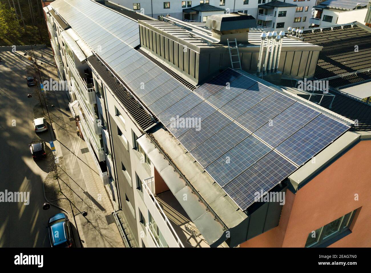 Aerial view of solar photovoltaic panels on a roof top of residential ...