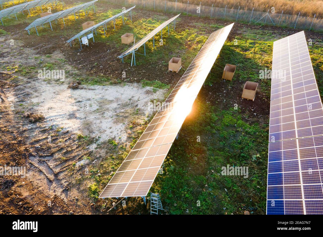 Aerial view of solar power plant under construction on green field ...