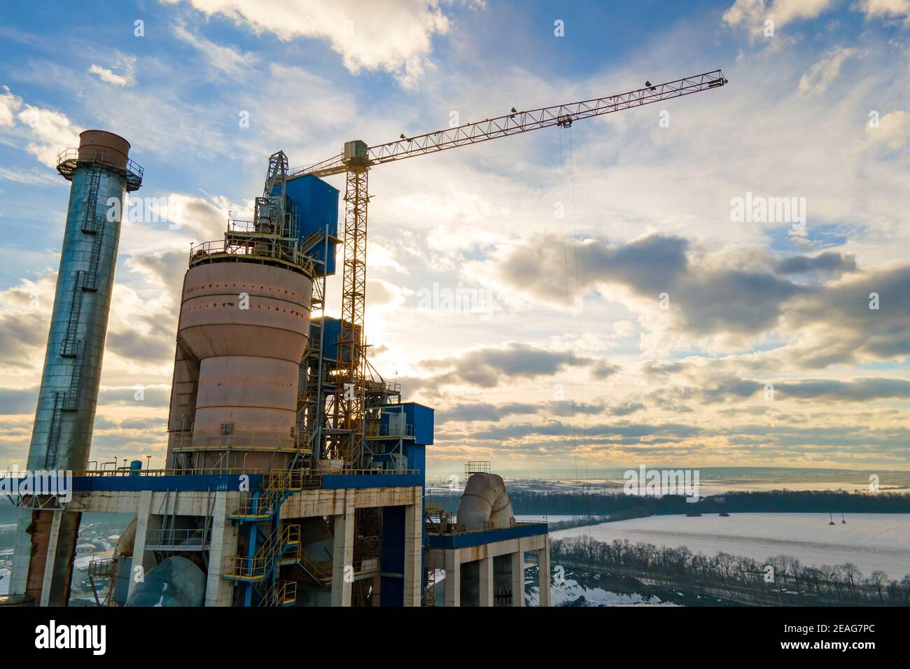 Aerial view of cement plant with high factory structure and tower crane ...