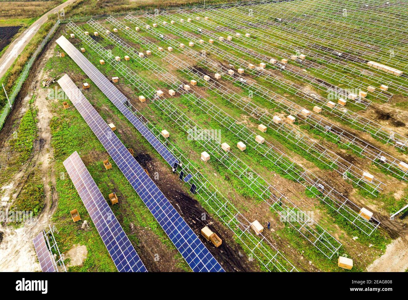Aerial view of solar power plant under construction on green field ...