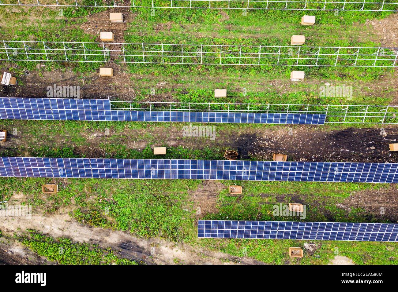 Aerial view of solar power plant under construction on green field ...