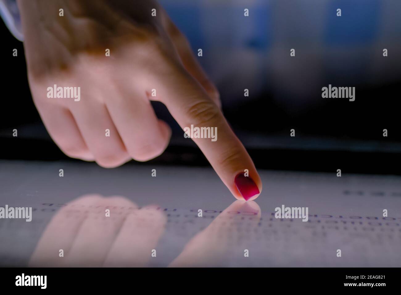 Woman finger using multimedia touchscreen display of interactive kiosk ...