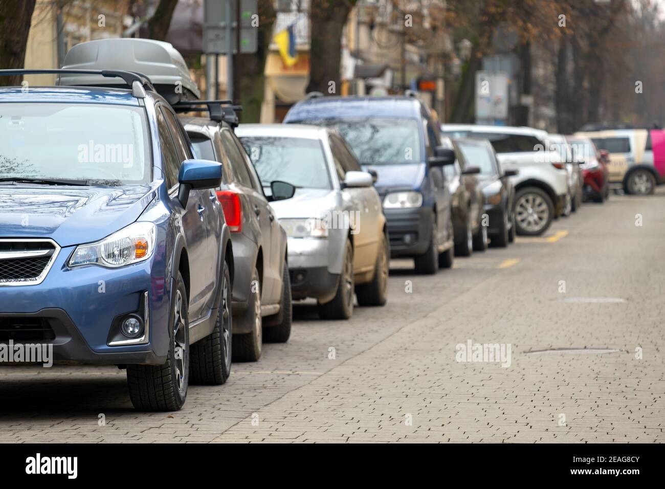 Cars parked in a row on a city street side Stock Photo - Alamy