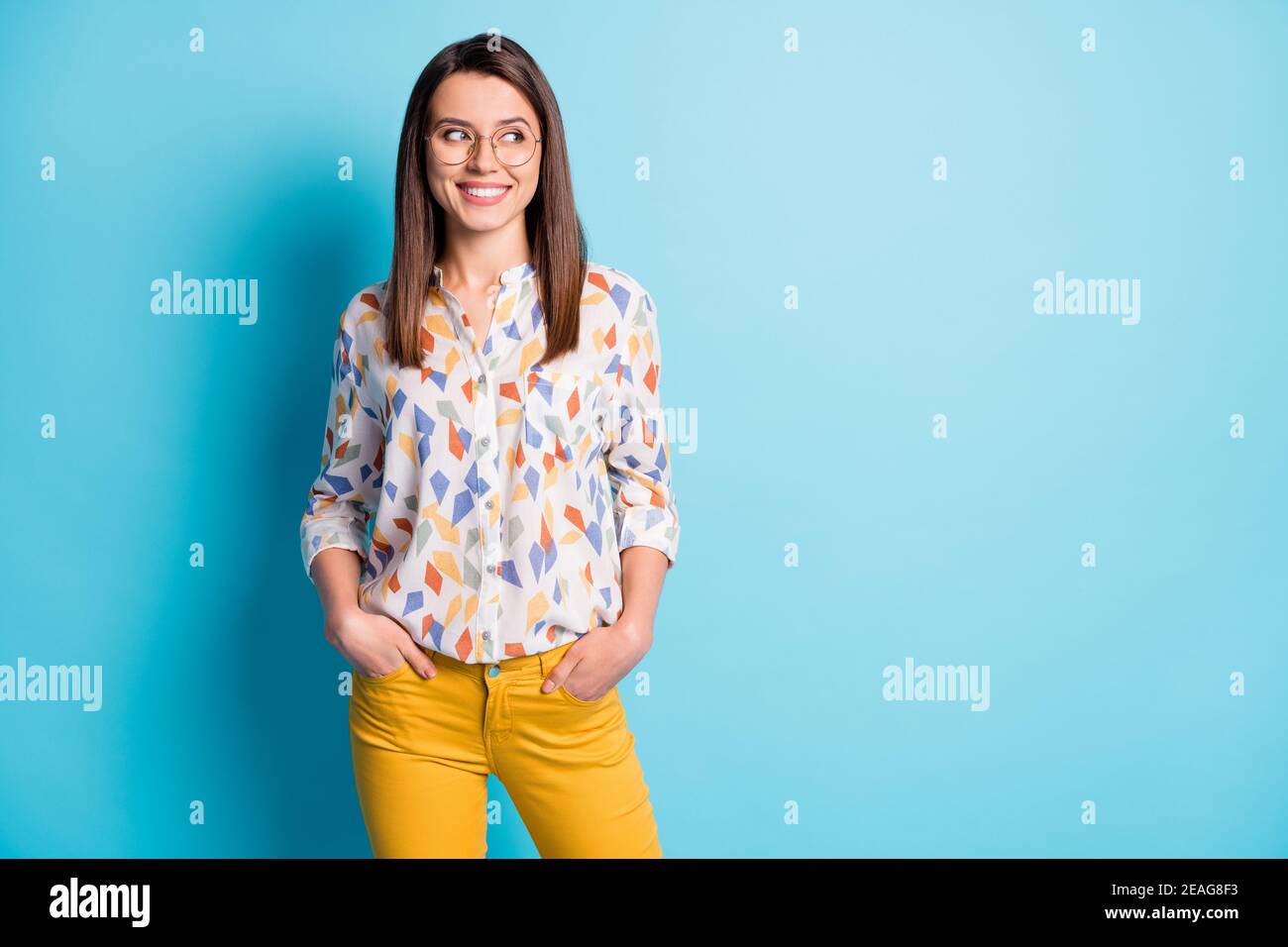 Photo of pretty girl hands pockets look side empty space wear specs ...