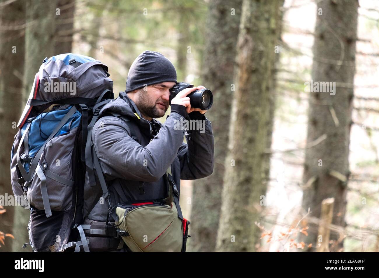 Photographer with hiking backpack taking pictures of nature with ...