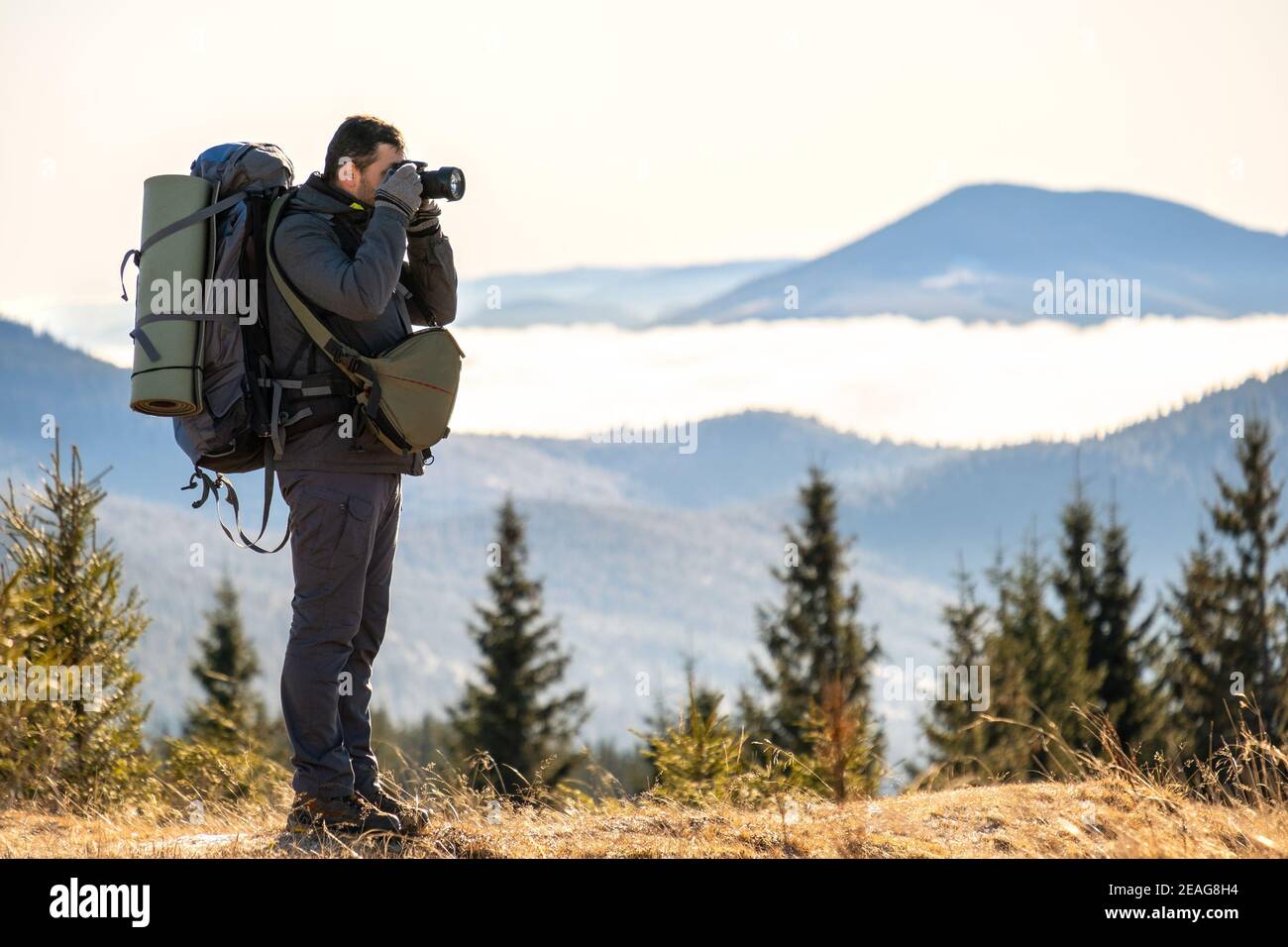 Photographer with hiking backpack taking pictures of nature with ...