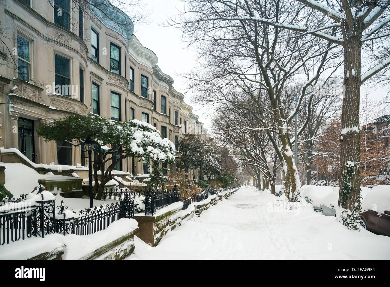 Winter scene with snow covered cars parked along streets in Brooklyn ...