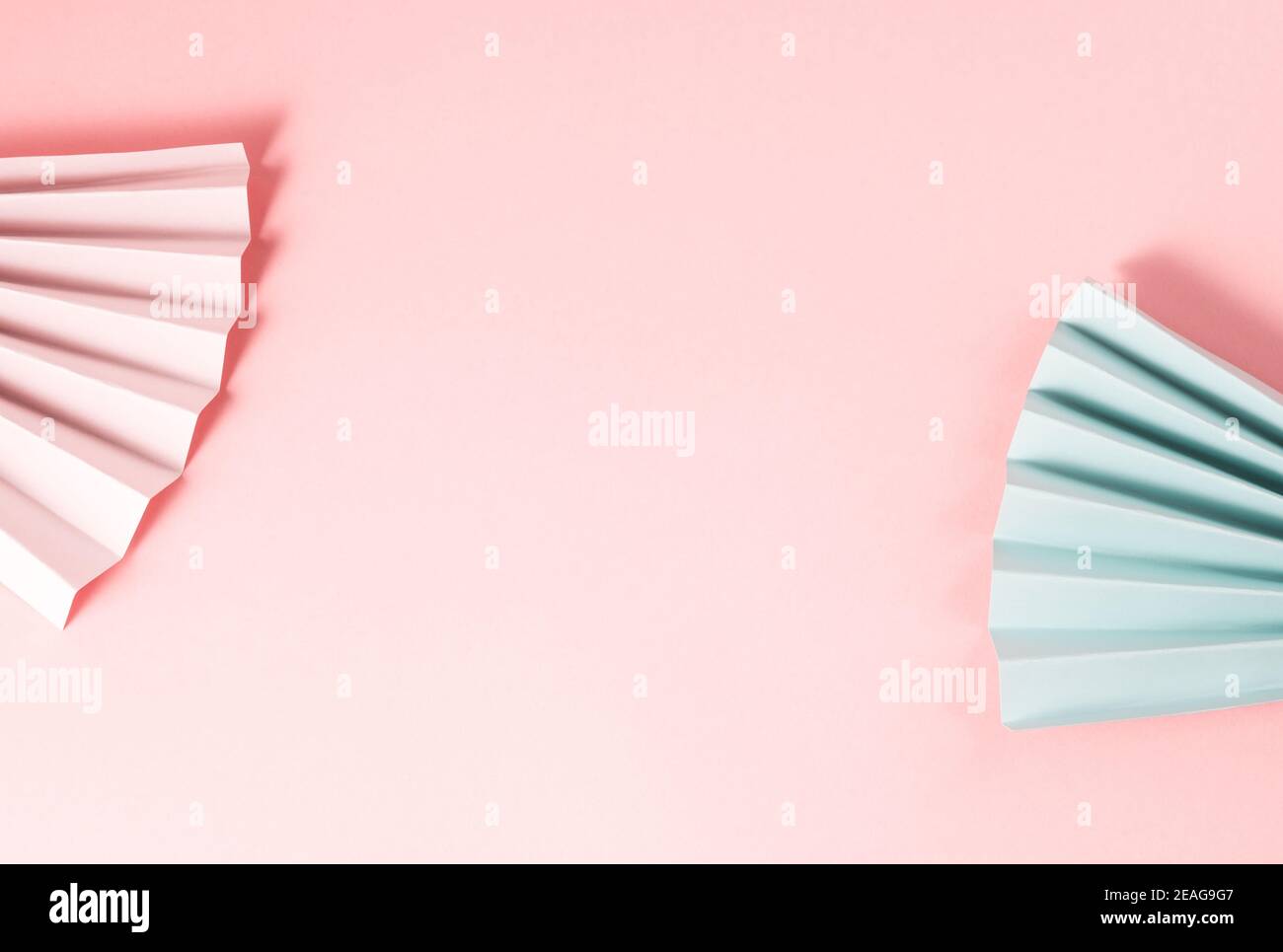 Pastel color paper fans on pink background Stock Photo - Alamy