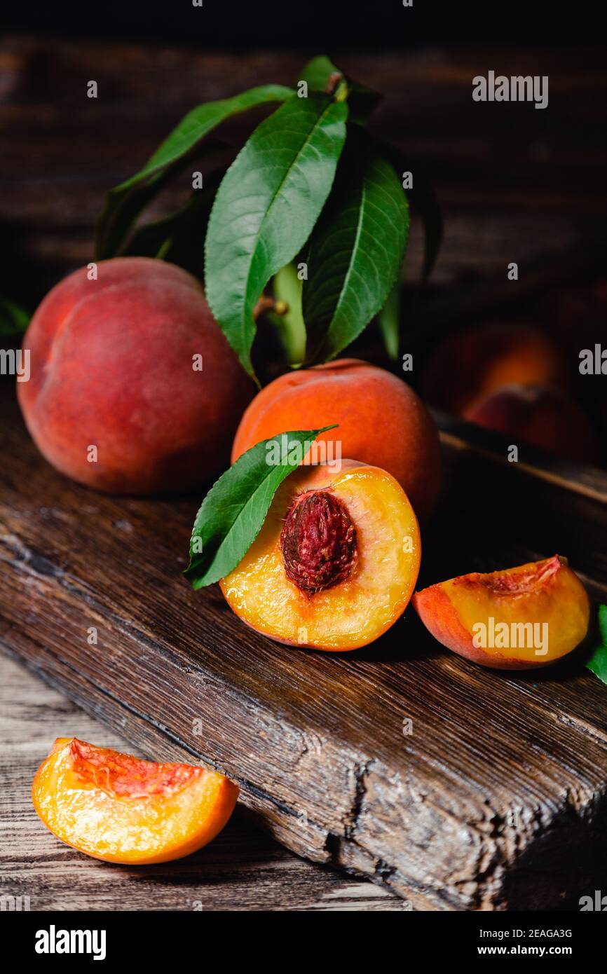 Juicy ripe peach on dark wooden rustic cutting board. Delicious farm ...