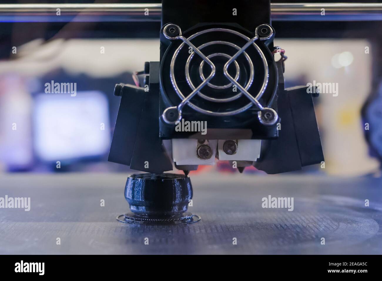 Close up: modern 3D printer machine printing black plastic model at ...