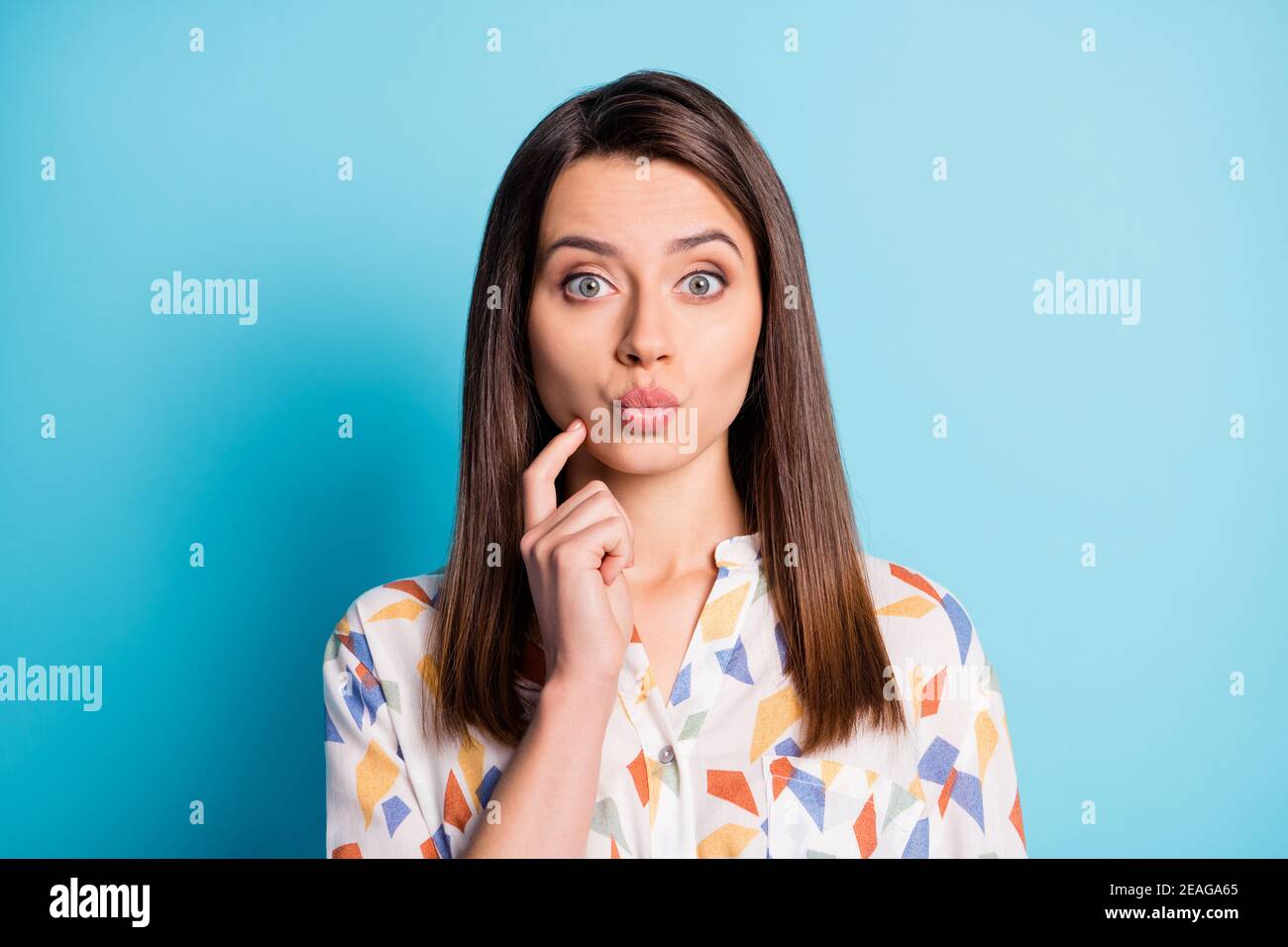 Photo of pretty young girl finger cheek look camera space funny face ...