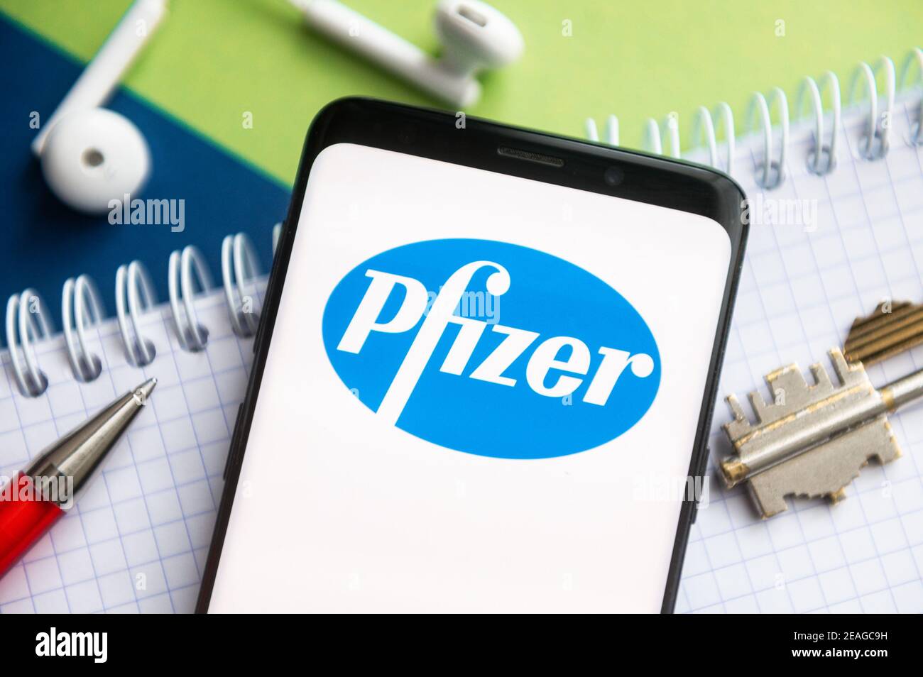 In this photo illustration, a Pfizer logo seen displayed on a ...