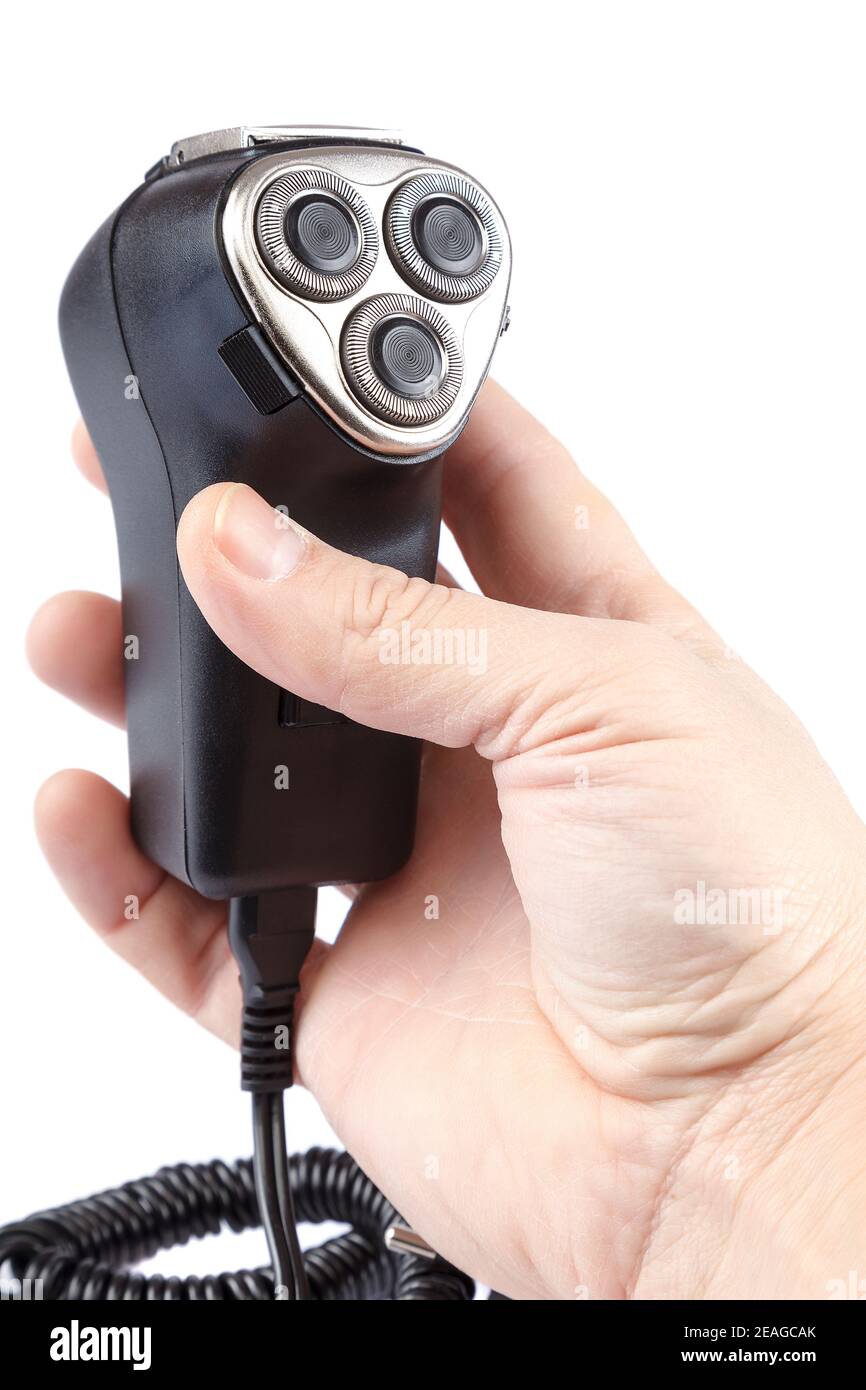 Electric razor in hand isolated on white background Stock Photo - Alamy