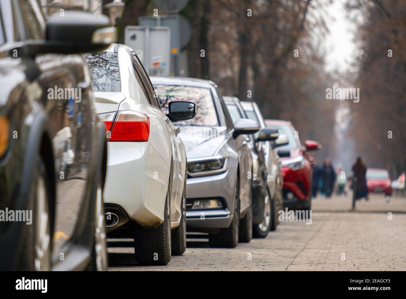 Cars parked in a row on a city street side Stock Photo - Alamy