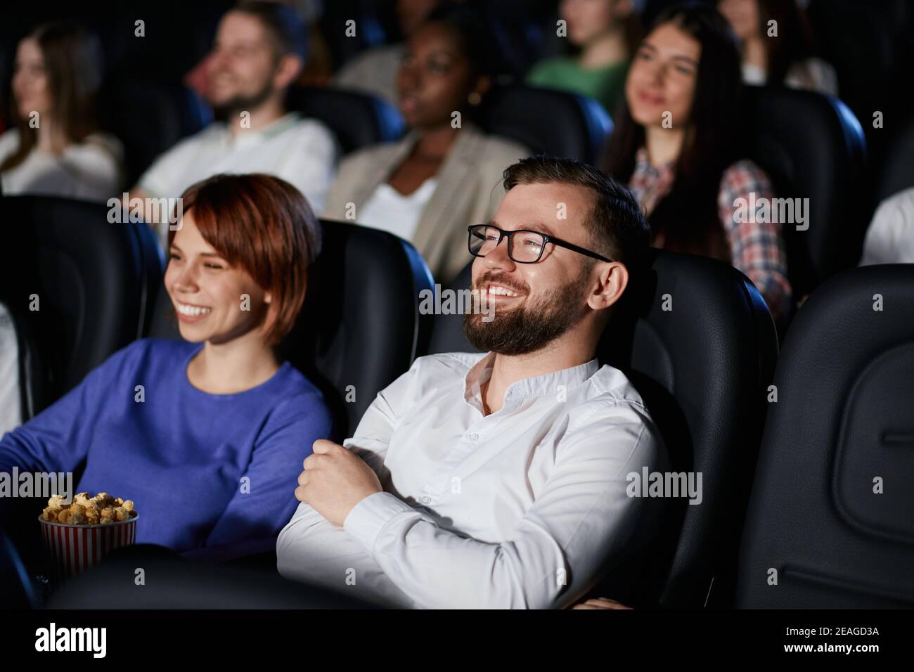 Caucasian couple watching funny comedy in cinema. Selective focus of ...