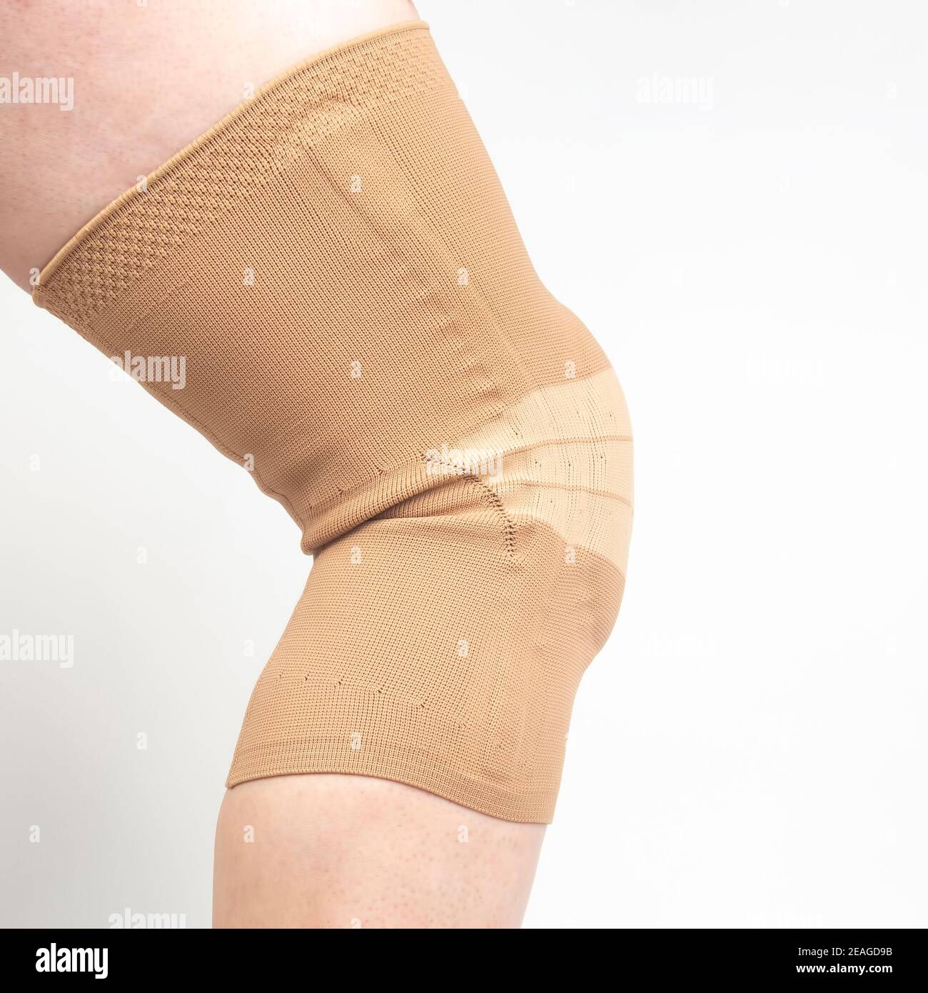 bandage for fixing the injured knee of the human leg on a white ...