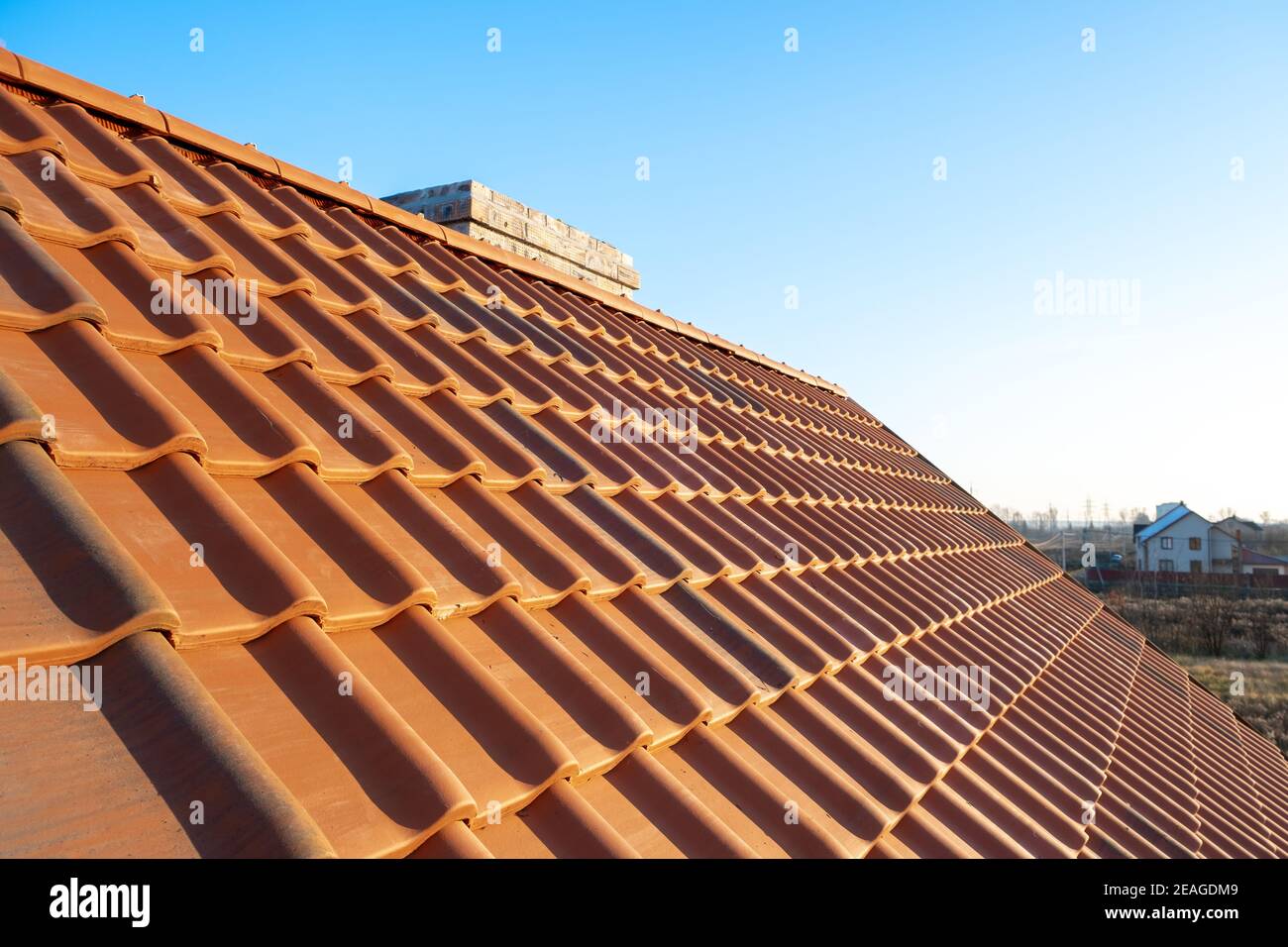 Overlapping rows of yellow ceramic roofing tiles mounted on wooden ...