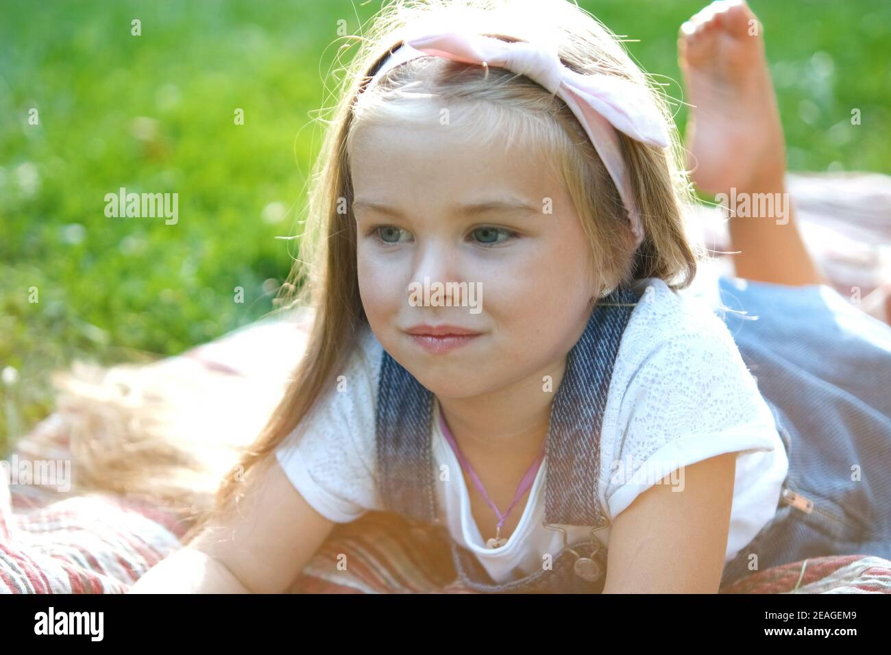 Portrait of pretty child girl resting outdoors in summer park Stock ...